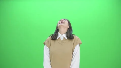 Beautiful lady laughing hard on green sc... | Stock Video | Pond5