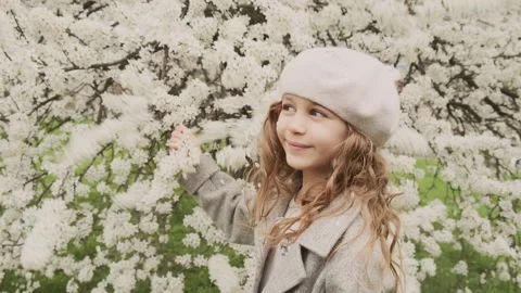 A beautiful little girl shaking a branch... | Stock Video | Pond5