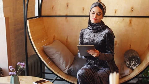 Beautiful muslim girl working with table... | Stock Video | Pond5