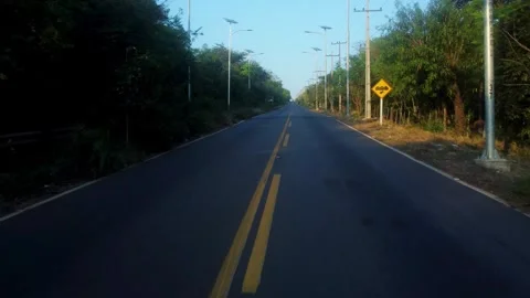 Beautiful paved road with forests on its... | Stock Video | Pond5