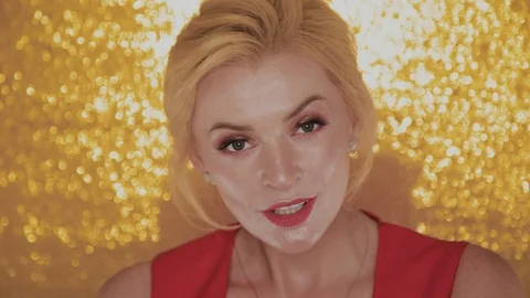 Beautiful photo model posing on a gold b... | Stock Video | Pond5