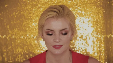 Beautiful photo model posing on a gold b... | Stock Video | Pond5