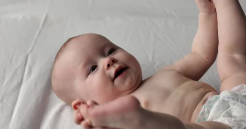 Beautiful playful baby in dry diaper pla... | Stock Video | Pond5