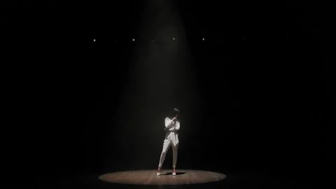 A beautiful singer on stage in the dark ... | Stock Video | Pond5