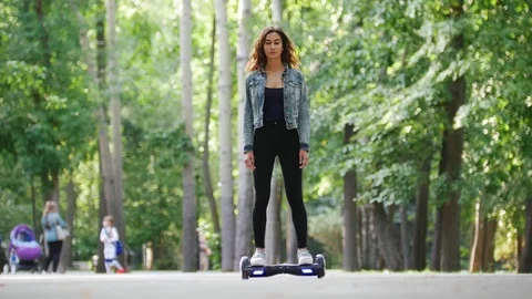 Beautiful slender girl rides a gyro in t... | Stock Video | Pond5