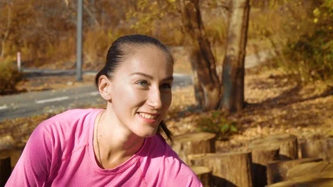 Beautiful smiling girl stretching in aut... | Stock Video | Pond5