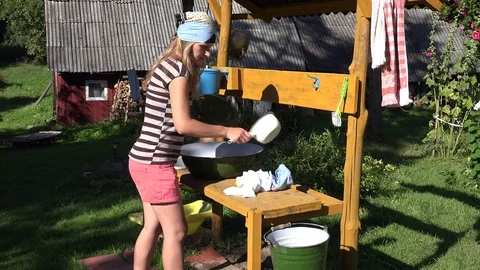 Beautiful villager woman washing clothes... | Stock Video | Pond5