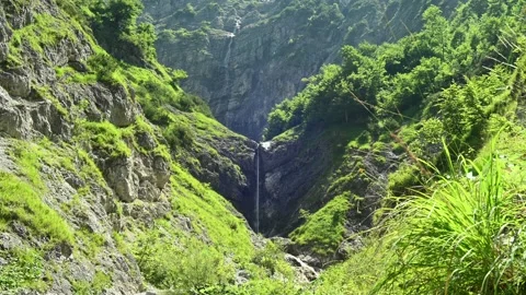 Beautiful waterfalls in a the end of a v... | Stock Video | Pond5