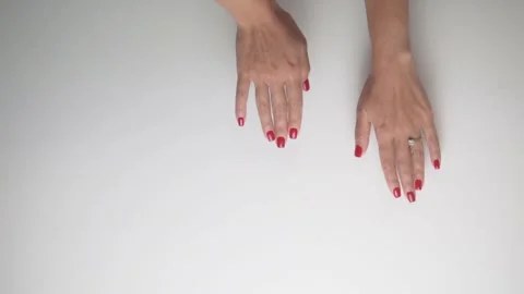 Beautiful white hands with bright red ma... | Stock Video | Pond5