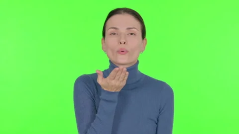 Beautiful Woman Giving Flying Kiss on Gr... | Stock Video | Pond5