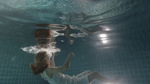 Beautiful woman with long red hair swimm... | Stock Video | Pond5