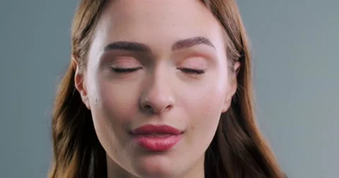 Beautiful woman rolling eyes on light gr... | Stock Video | Pond5