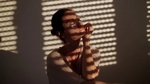 Beautiful woman with a shadow pattern on... | Stock Video | Pond5