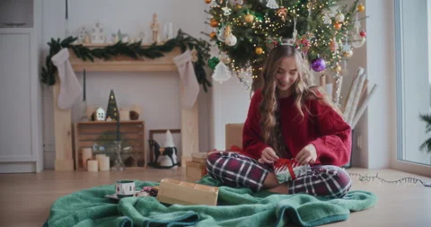 Beautiful woman wrapping Christmas gifts... | Stock Video | Pond5