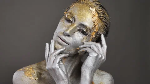 Beautiful young female model with gold a... | Stock Video | Pond5