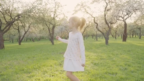 Beautiful young lady dizzy in the park. ... | Stock Video | Pond5