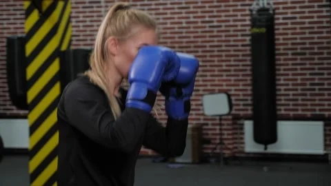 A beautiful young woman in blue boxing g... | Stock Video | Pond5