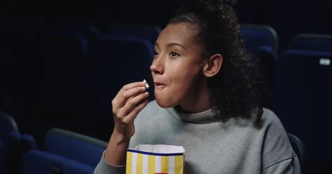 A beautiful young woman sat in a movie t... | Stock Video | Pond5