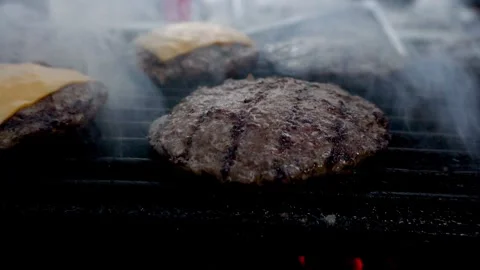 Beef burgers cooking on a hot grill | Stock Video | Pond5