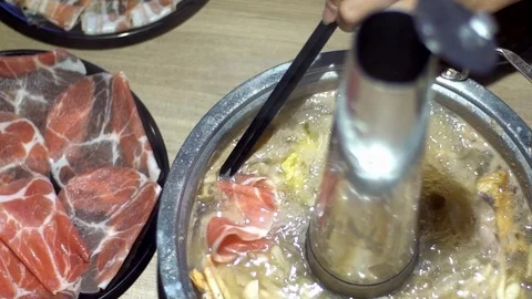 Beef raw meat hold with chopsticks. Hot ... | Stock Video | Pond5