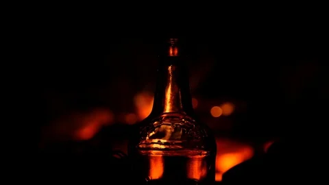 beer bottle on a fire background in a da... | Stock Video | Pond5