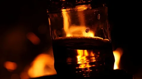 beer bottle on a fire background in a da... | Stock Video | Pond5