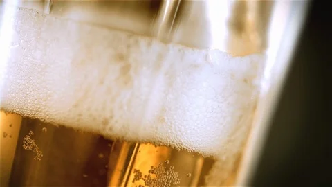 Beer is pouring into angled glass. IPA o... | Stock Video | Pond5