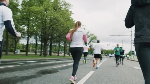 Behind of athletes running marathon, gir... | Stock Video | Pond5