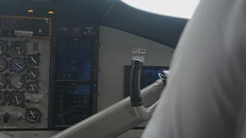Behind pilot looking at control wheel of... | Stock Video | Pond5