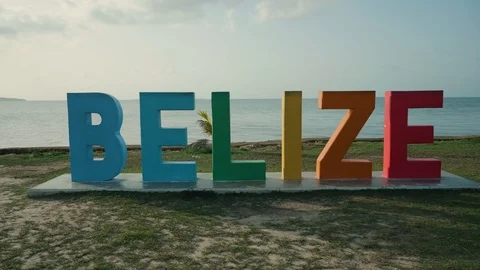 Belize Sign by shoreline with blue ocean... | Stock Video | Pond5