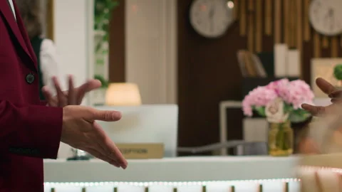 Bellboy shaking hands with hotel guest | Stock Video | Pond5