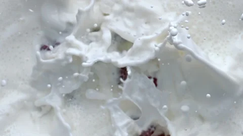 Berries throwing splashing milk cocktail... | Stock Video | Pond5