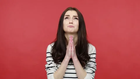 Beseeching woman holds hands together wh... | Stock Video | Pond5