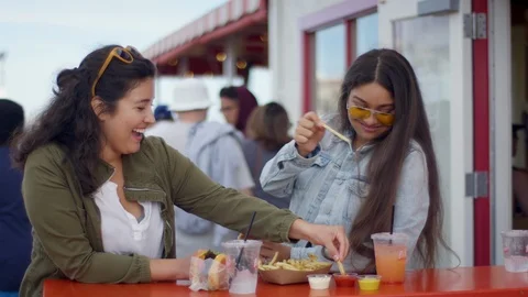 Best Friends Enjoy Tasty French Fries On... | Stock Video | Pond5