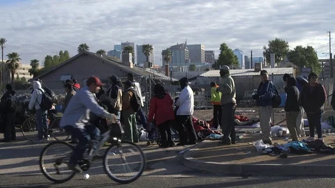 A bicyclist rides past a long line of... | Stock Video | Pond5