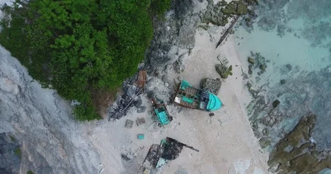 Big blue ship is wrecked at the beach on... | Stock Video | Pond5