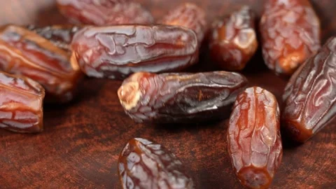 Big dates slowly falling down on brown p... | Stock Video | Pond5