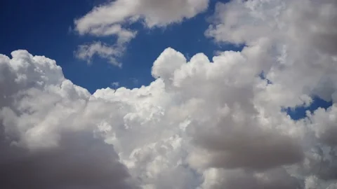 Big, fluffy clouds billowing and blowing... | Stock Video | Pond5