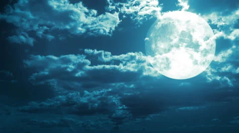 Big moon behind fast moving clouds. | Stock Video | Pond5