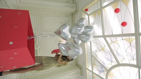 Big red box with balloons, girl opens su... | Stock Video | Pond5