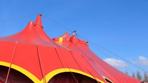 Big red circus tent against blue sky | Stock Video | Pond5