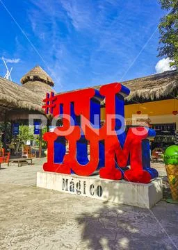 Photograph: Big red sign lettering writing Tulum Magico in Mexico ...