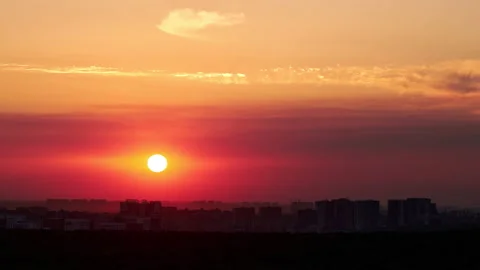 Big red sun over the roofs of city build... | Stock Video | Pond5