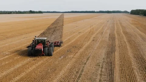 Big red Tractor Pulling Disc Harrow Thro... | Stock Video | Pond5