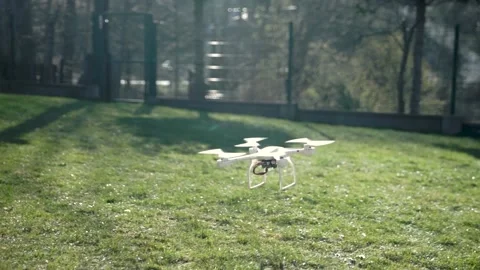 Big white drone launched in garden | Stock Video | Pond5