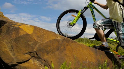 on a bike on rocks | Stock Video | Pond5