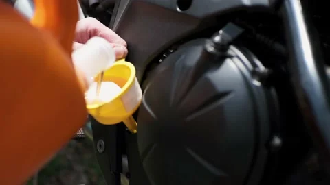 Biker change engine oil on motorcycle. P... | Stock Video | Pond5