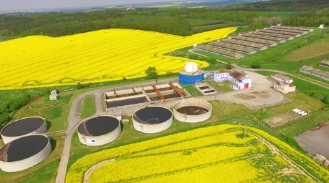 Biogas plant from pig farm in green fiel... | Stock Video | Pond5