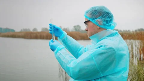 Biologist Looks At Flask With Water Take... | Stock Video | Pond5