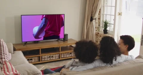 Biracial family watching tv with african... | Stock Video | Pond5